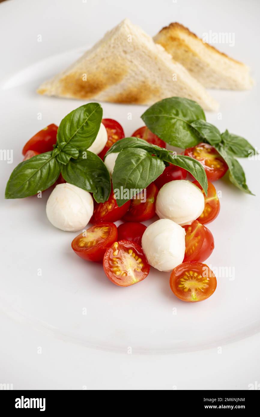 Italian insalada caprese on a white plate Stock Photo - Alamy