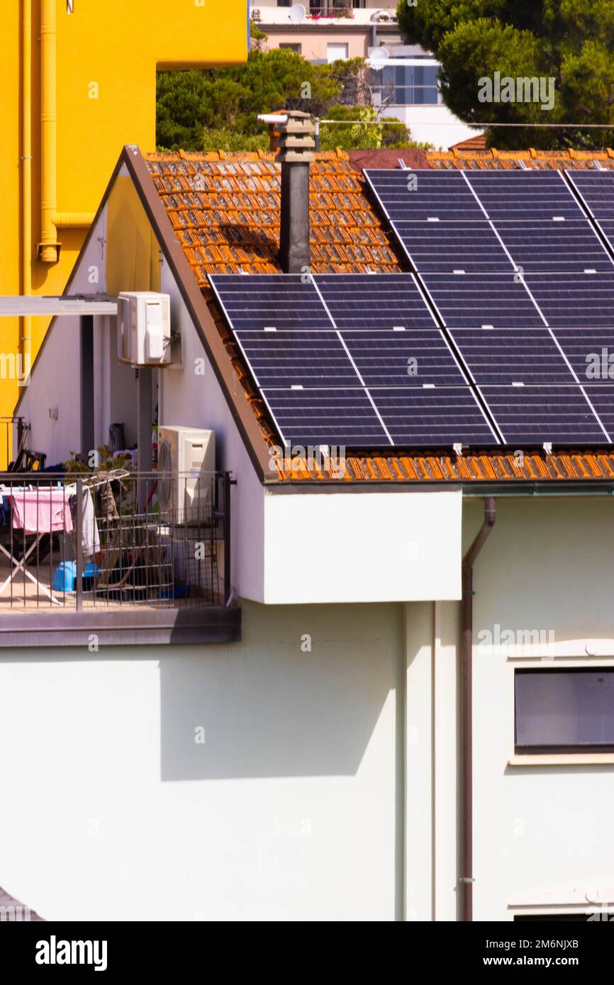 Solar panels on pitched tiled roof, Rimini, Italy Stock Photo - Alamy