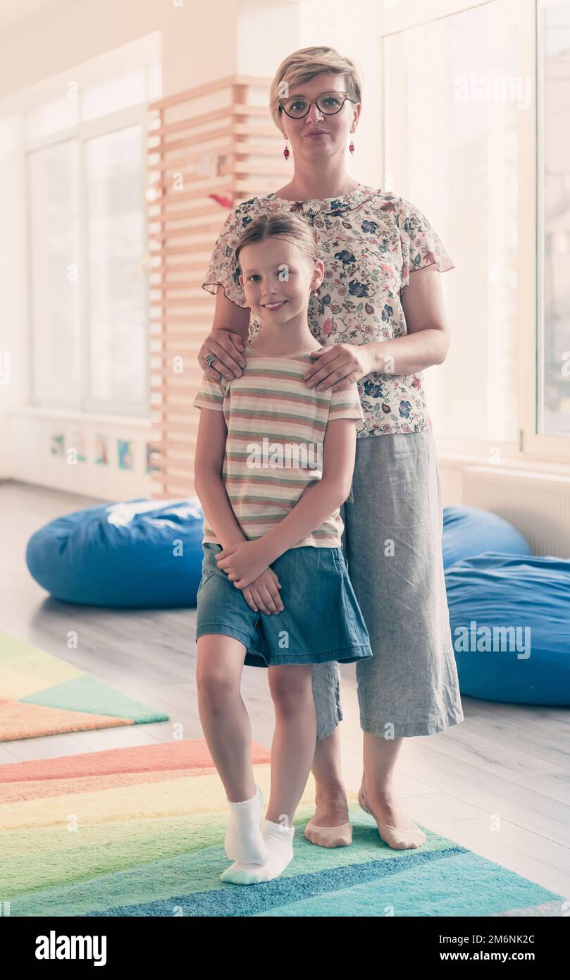 Portrait of a mother and daughter in a modern institution for preschool ...