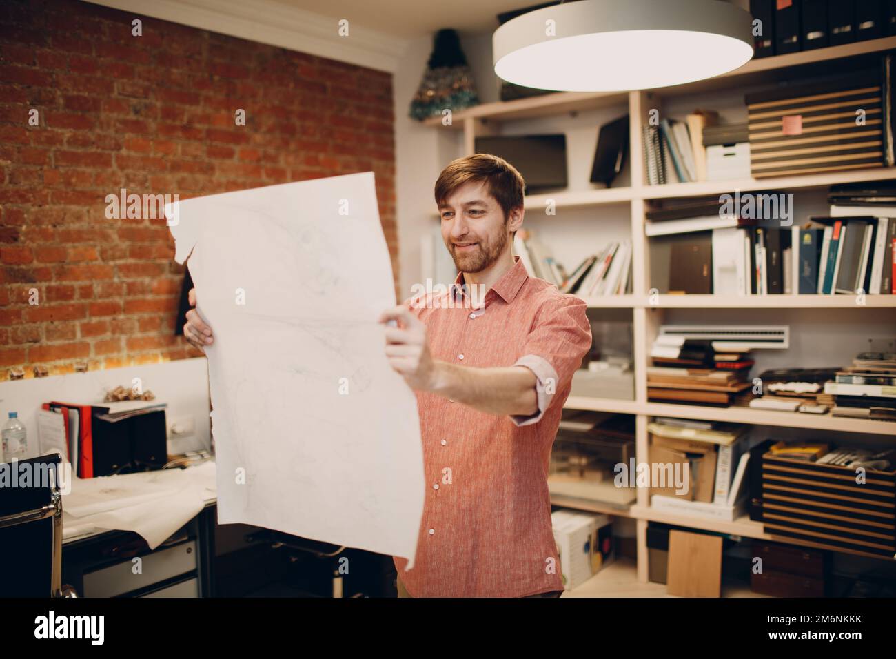 Architect with blueprints and layout design project at office Stock ...