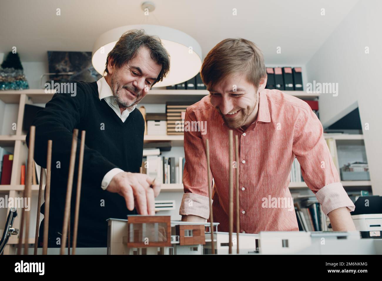 Architects with blueprints and layout design project at office Stock ...