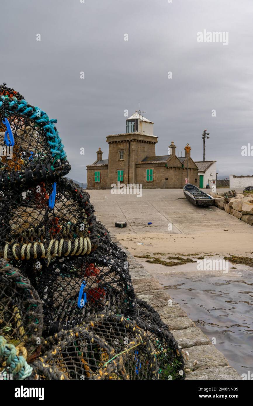 Blacksod harbor and lighthouse with many crab traps and lobster pots on ...