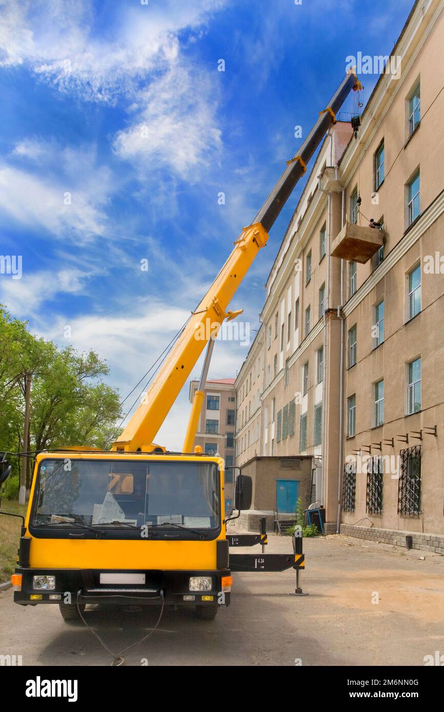 Big Power Mobile Crane on a road and tower crane in construction site ...