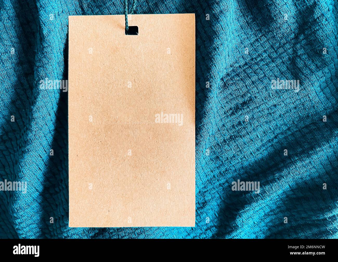 Blank fashion label tag, sale price card on luxury fabric background ...