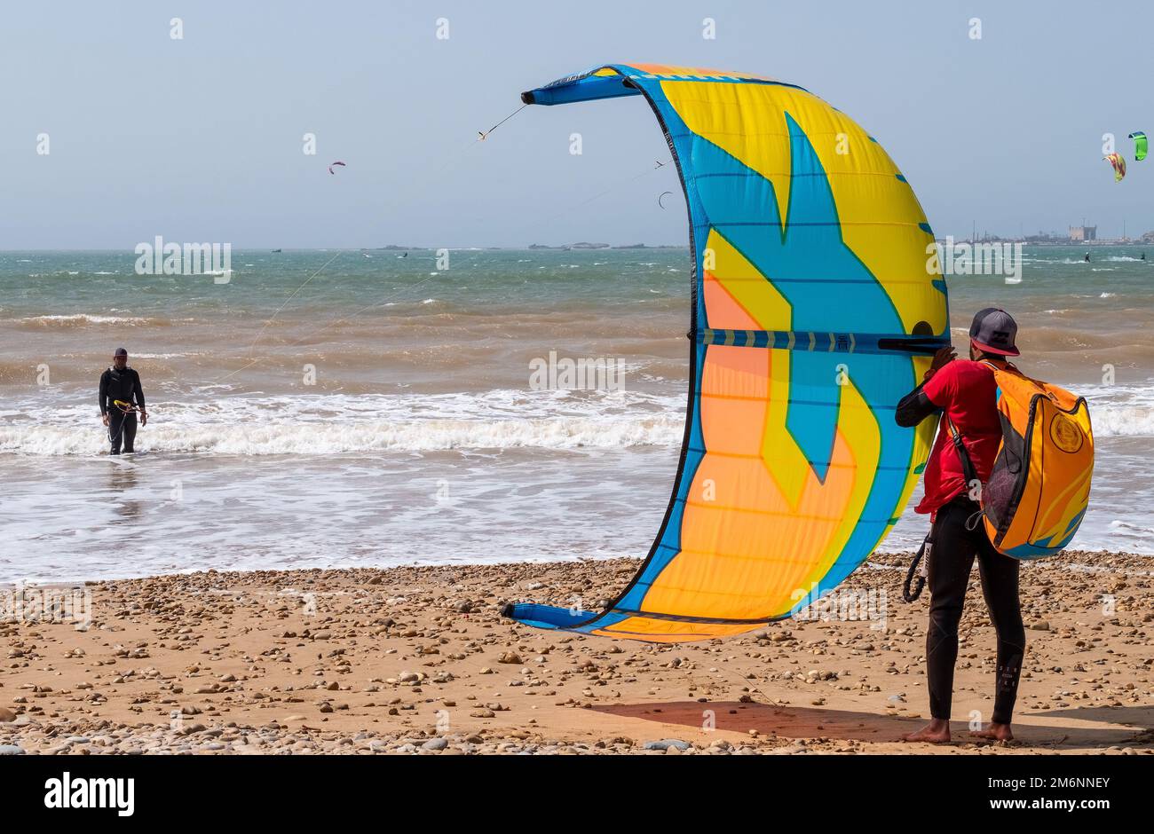 Soaring paraglider by the sea, a paraglider gets ready to take off ...