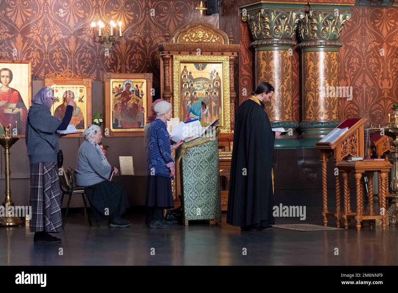 Orthodox priest holding the mass in the Church of the Dormition of the ...