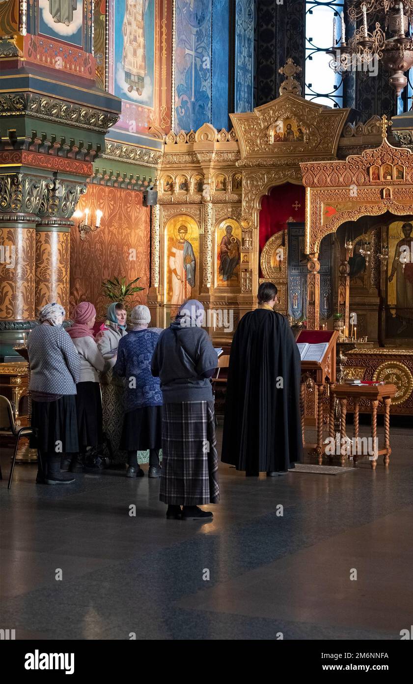 Orthodox priest holding the mass in the Church of the Dormition of the ...