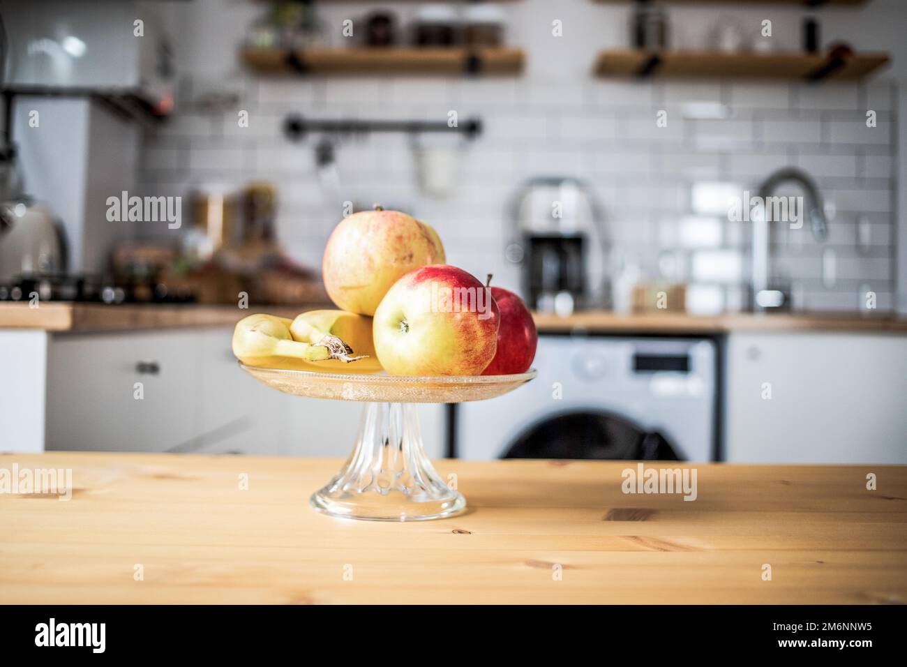 Fresh fruit apples and bananas in modern kitchen Stock Photo - Alamy