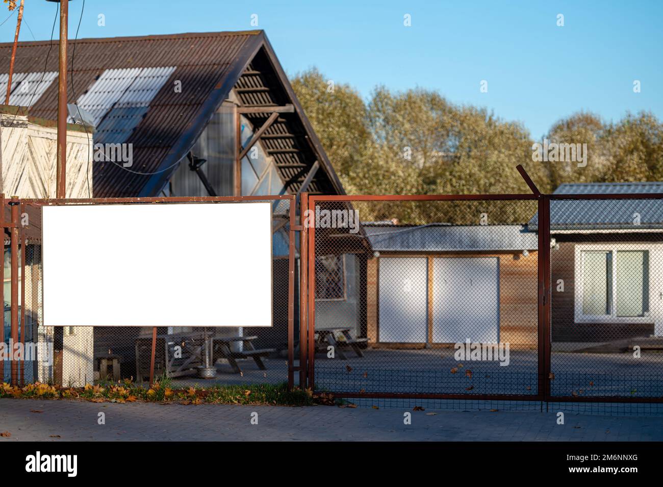 Blank white advert banner with mockup space on metal fence Stock Photo ...