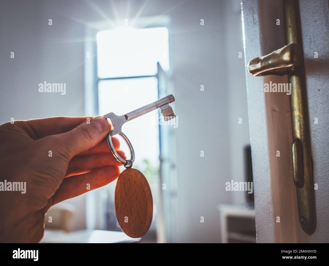 Key opening white door to a modern home Stock Photo - Alamy