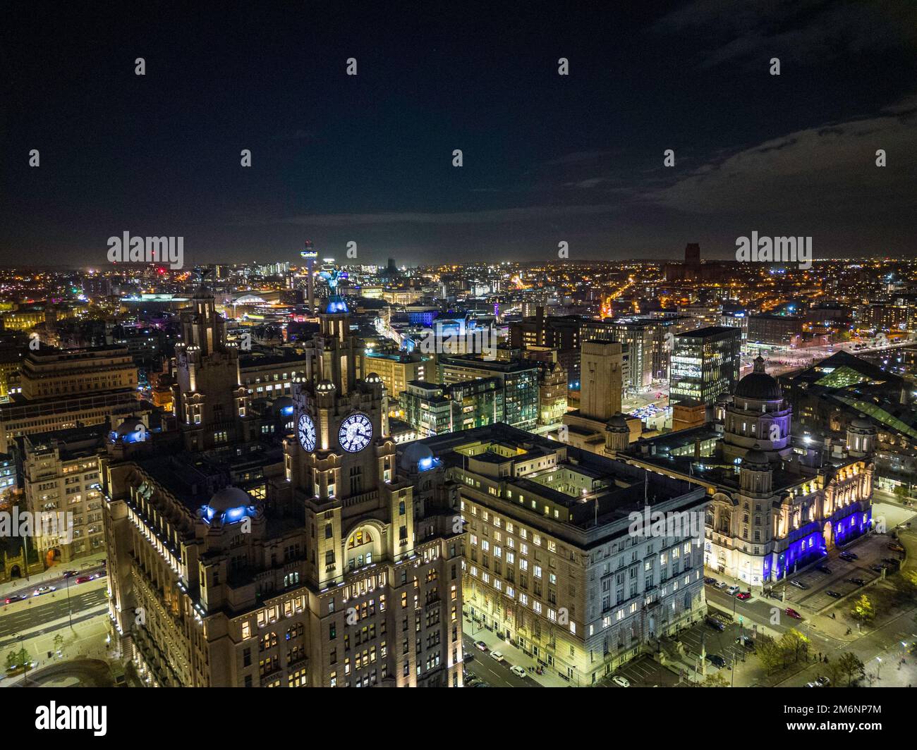 An aerial view of the Liverpool cityscape at night with illuminated ...