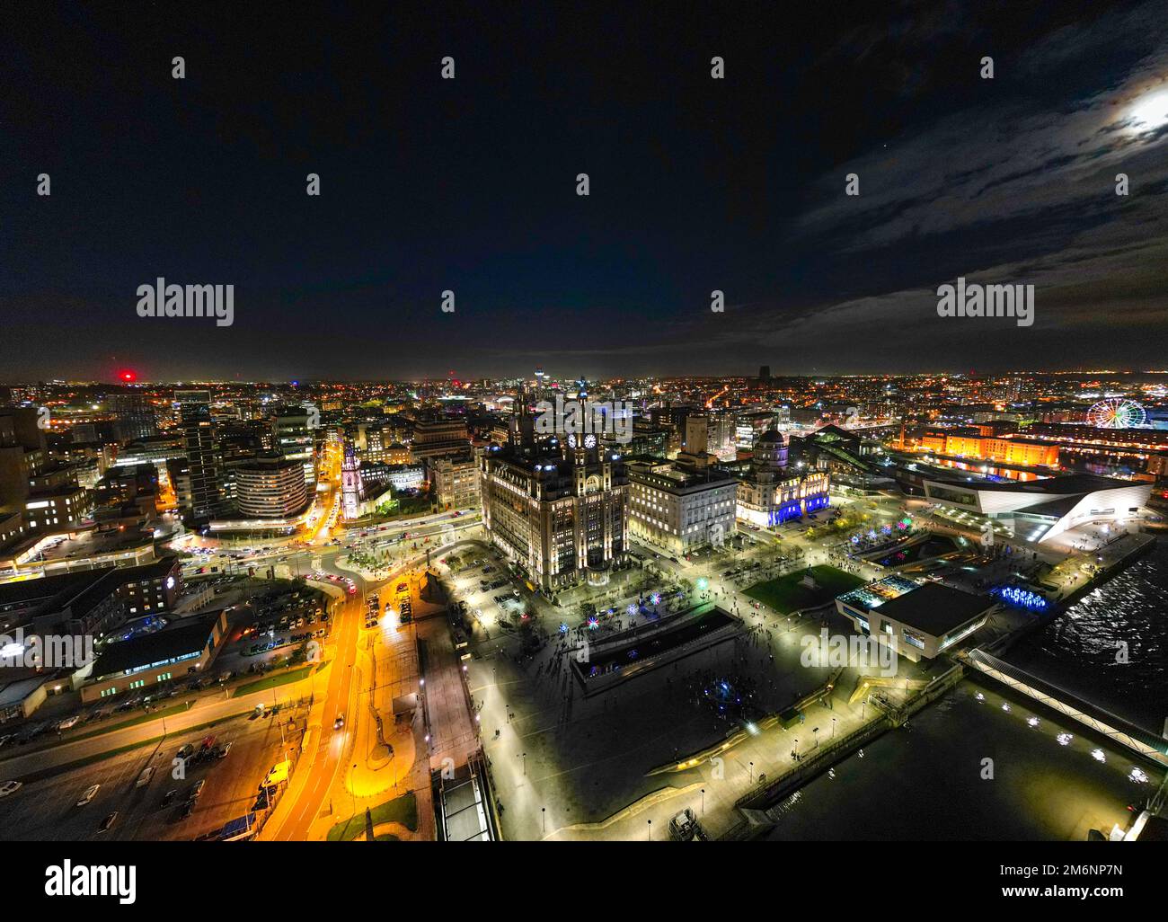 An aerial view of the Liverpool cityscape at night with illuminated ...