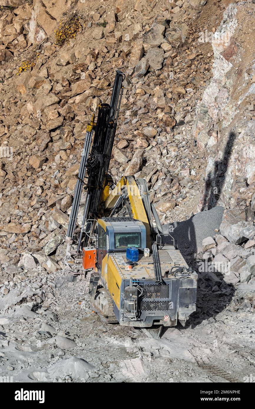 Drilling machine in open cast mining quarry Stock Photo - Alamy