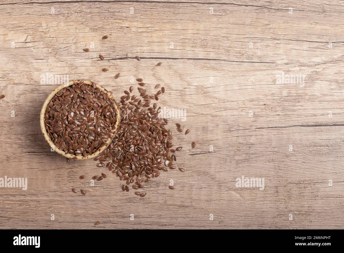flax seeds in a wooden bowl on a wooden background, top view Stock ...