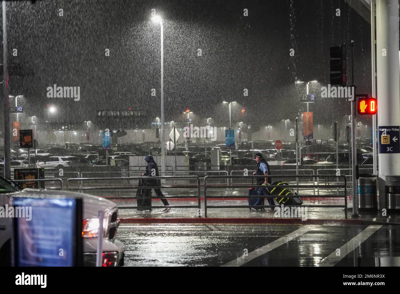 People walk on the street during the strong storm. A strong storm has ...