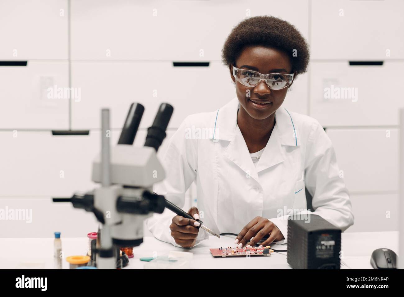 Scientist african american woman working in laboratory with electronic ...