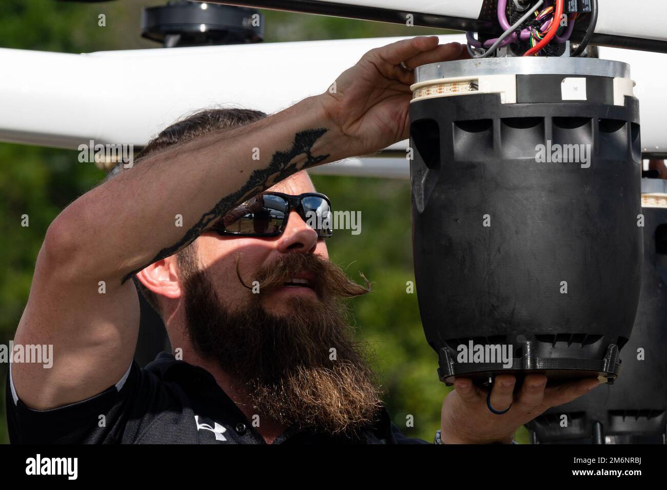 Jace McCown, chief lead pilot from Lift Aircraft, installs a battery ...