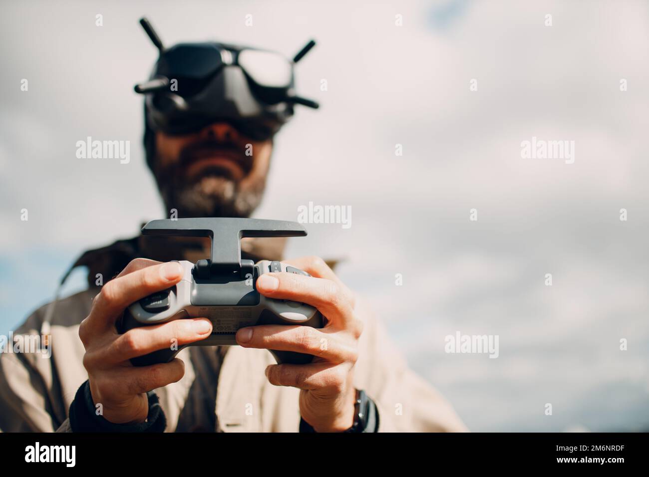 Man controlling fpv quadcopter drone with goggles antenna remote ...