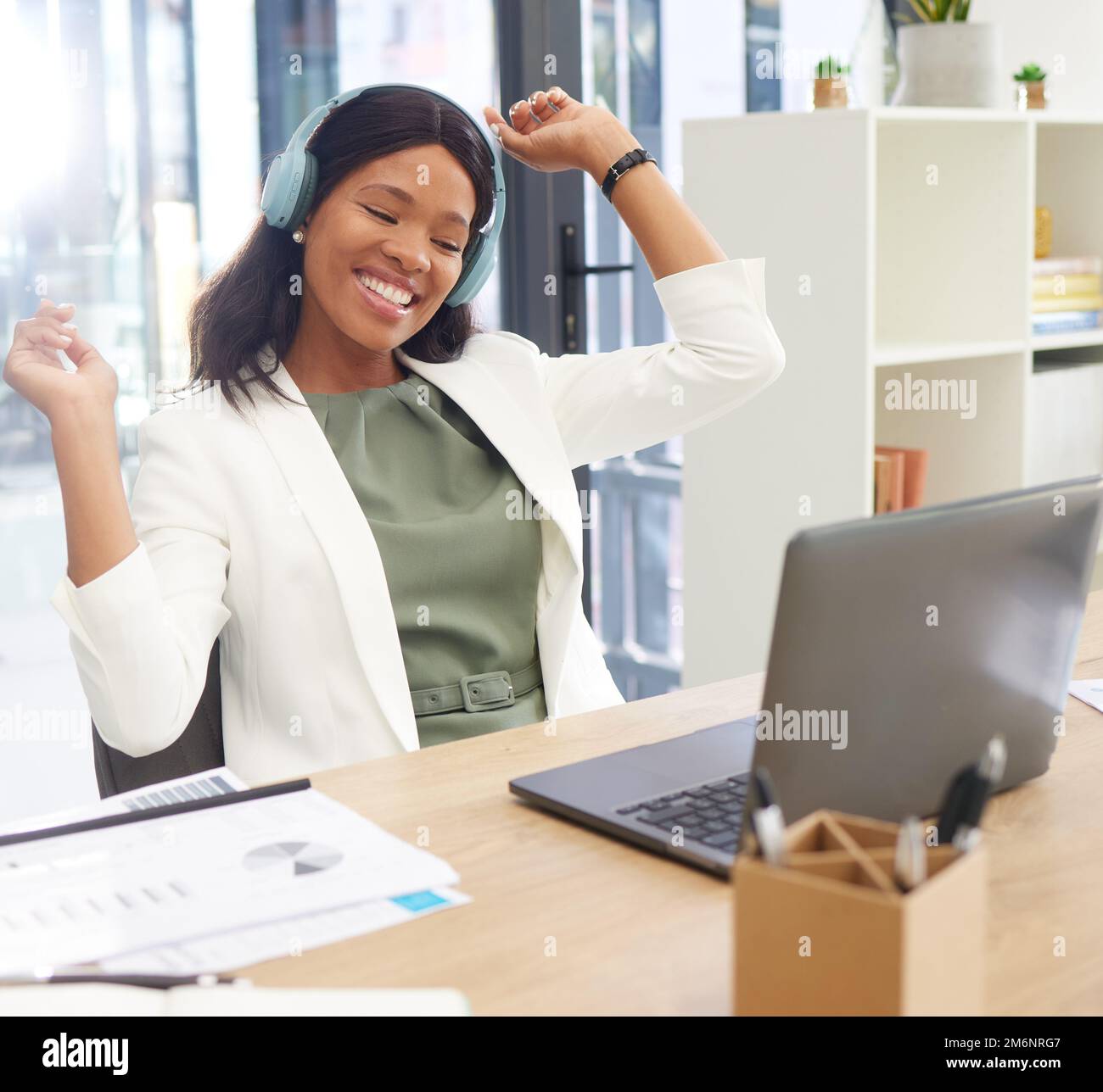 Business, black woman and celebration with headphones, excited and ...