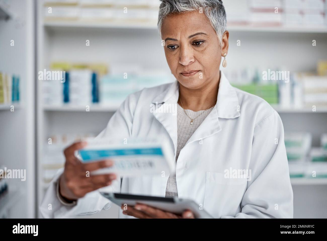 Pharmacist woman, tablet and reading box for information, stock or ...