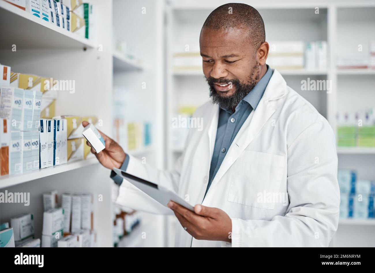 Pharmacy, medicine and black man with tablet to check inventory, stock ...