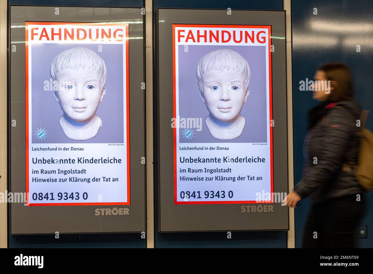 Munich, Germany. 05th Jan, 2023. A woman walks past a digital wanted ...