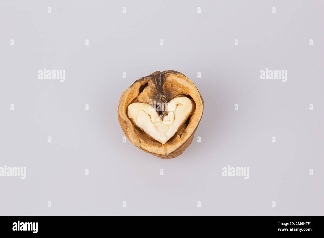 Half a walnut with a heart shape in the middle. The concept of love for ...