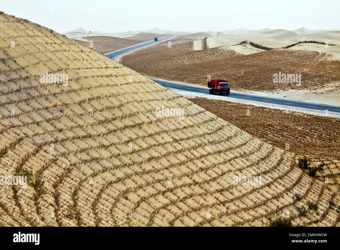 Planted straw to keep Taklamakan desert shifting-sands from moving onto ...