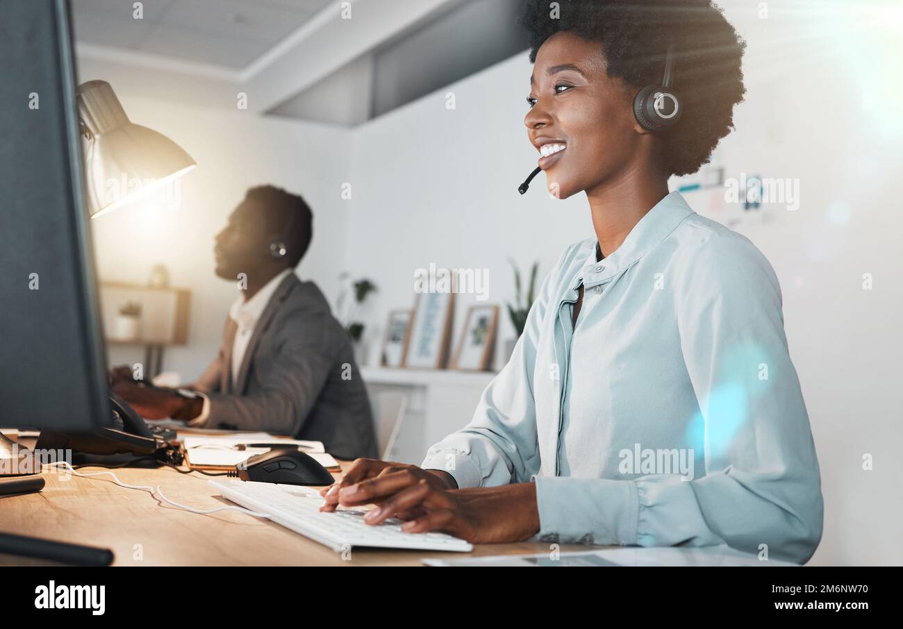 Call center, black woman and typing with computer, smile and focus for ...
