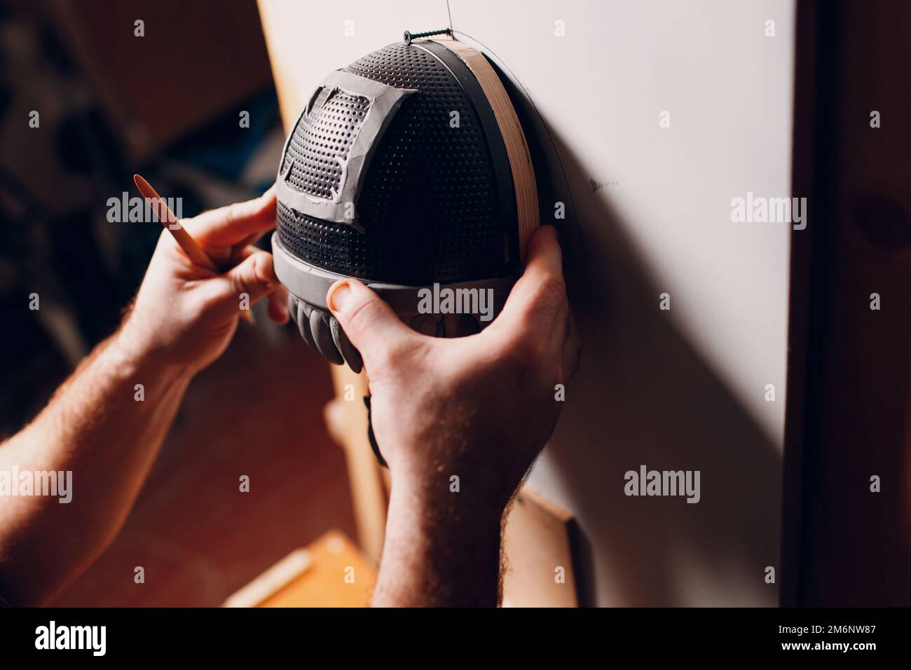 Artisan craftsman create mask based on plaster cast. Gypsum mold and ...