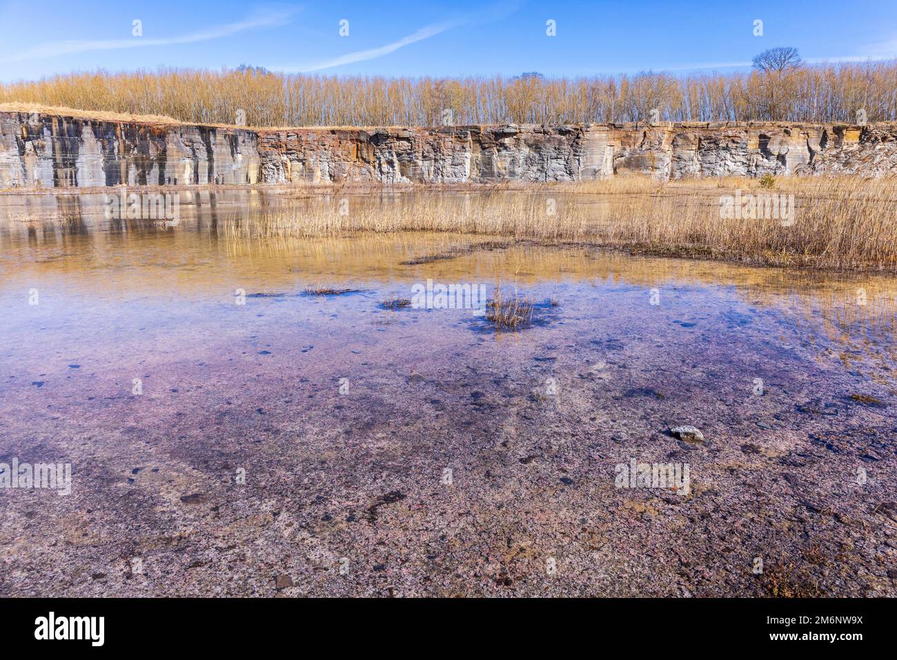 View at the rock face in an old quarry Stock Photo - Alamy