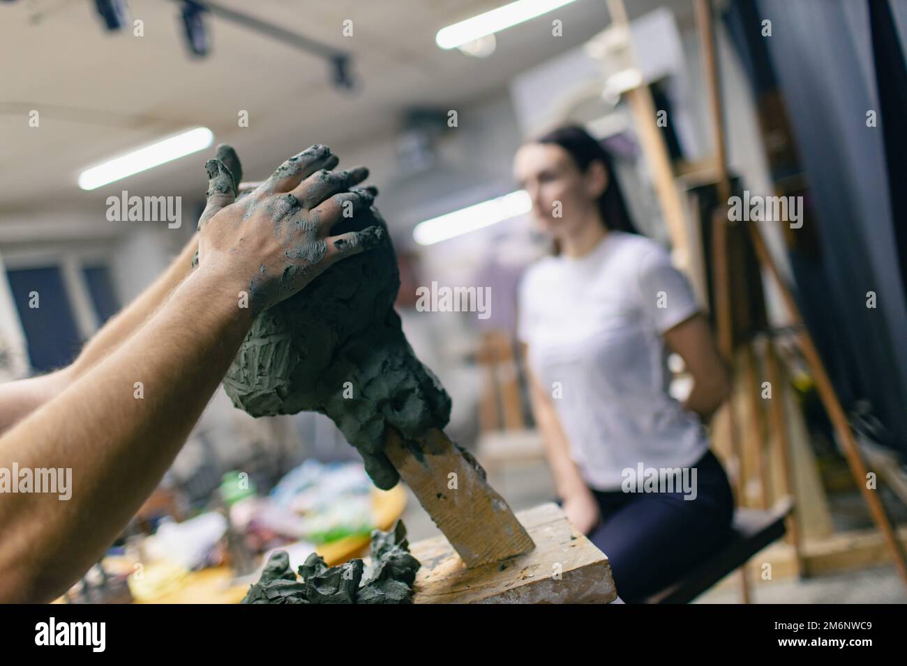 Man sculptor creates sculpt bust clay human woman sculpture. Statue ...