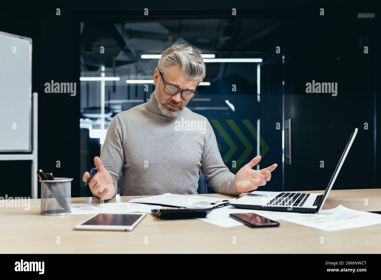 Dissatisfied gray haired boss in office, senior man disappointed with ...