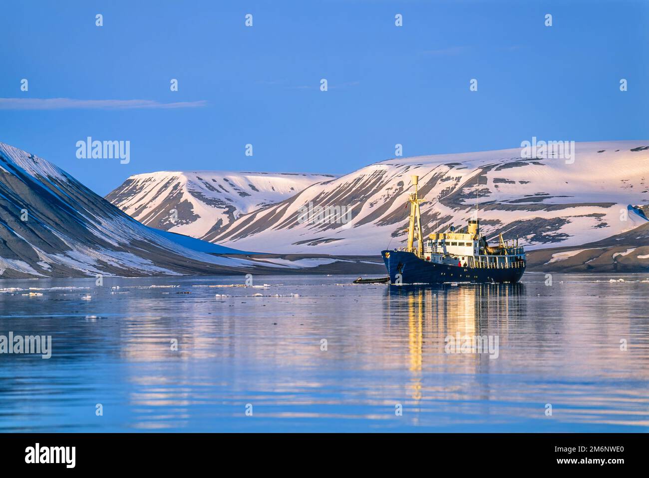 Ship in a bay at a mountainous coast at Svalbard Stock Photo - Alamy