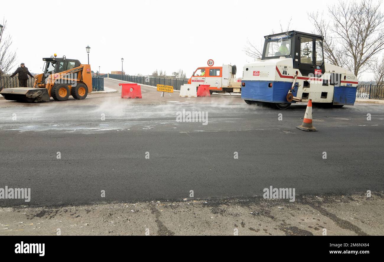Machines performing asphalting and paving work on a city road Stock ...