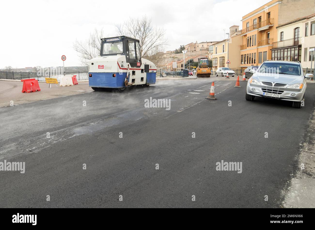 Machines performing asphalting and paving work on a city road Stock ...