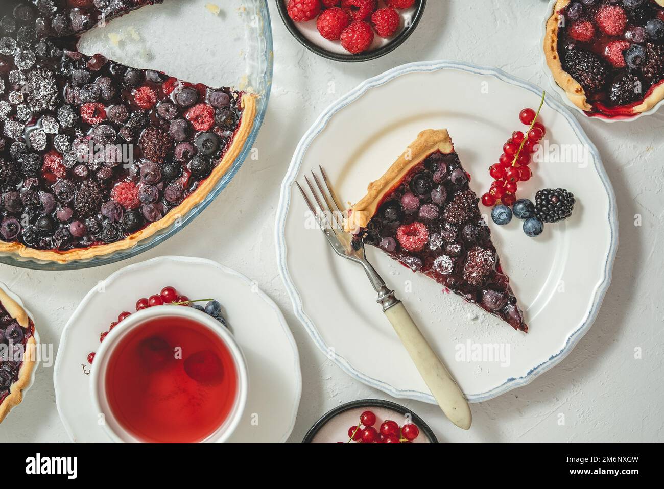 Sweet dessert with fresh baked forest fruit pie served with raspberry ...