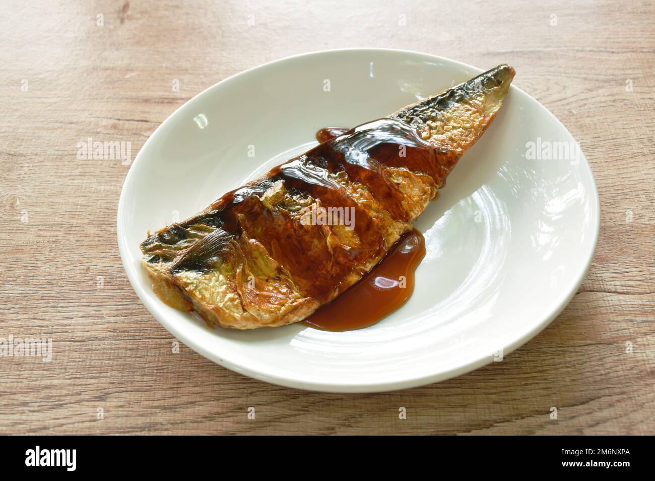 grilled saba fish or mackerel on plate dressing black sweet soybean ...