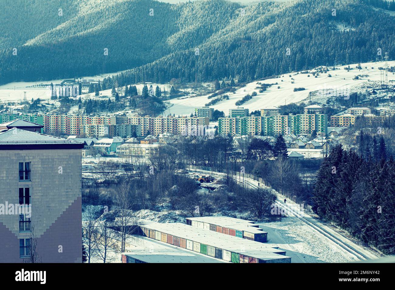View of a town in winter season.Beautiful snowy mountains in background ...