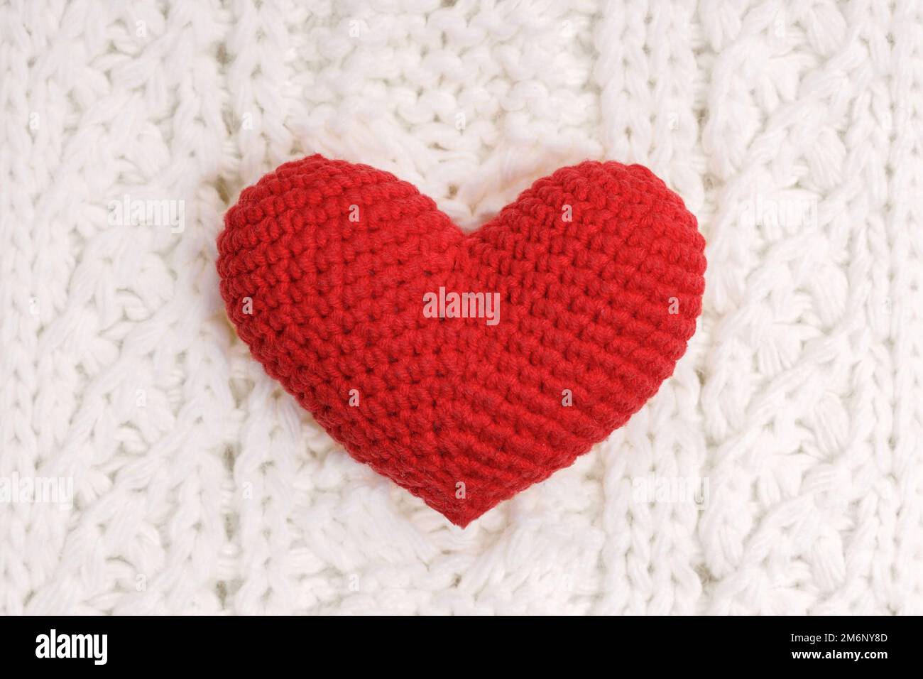 red knitted heart on a white woolen scarf Stock Photo - Alamy