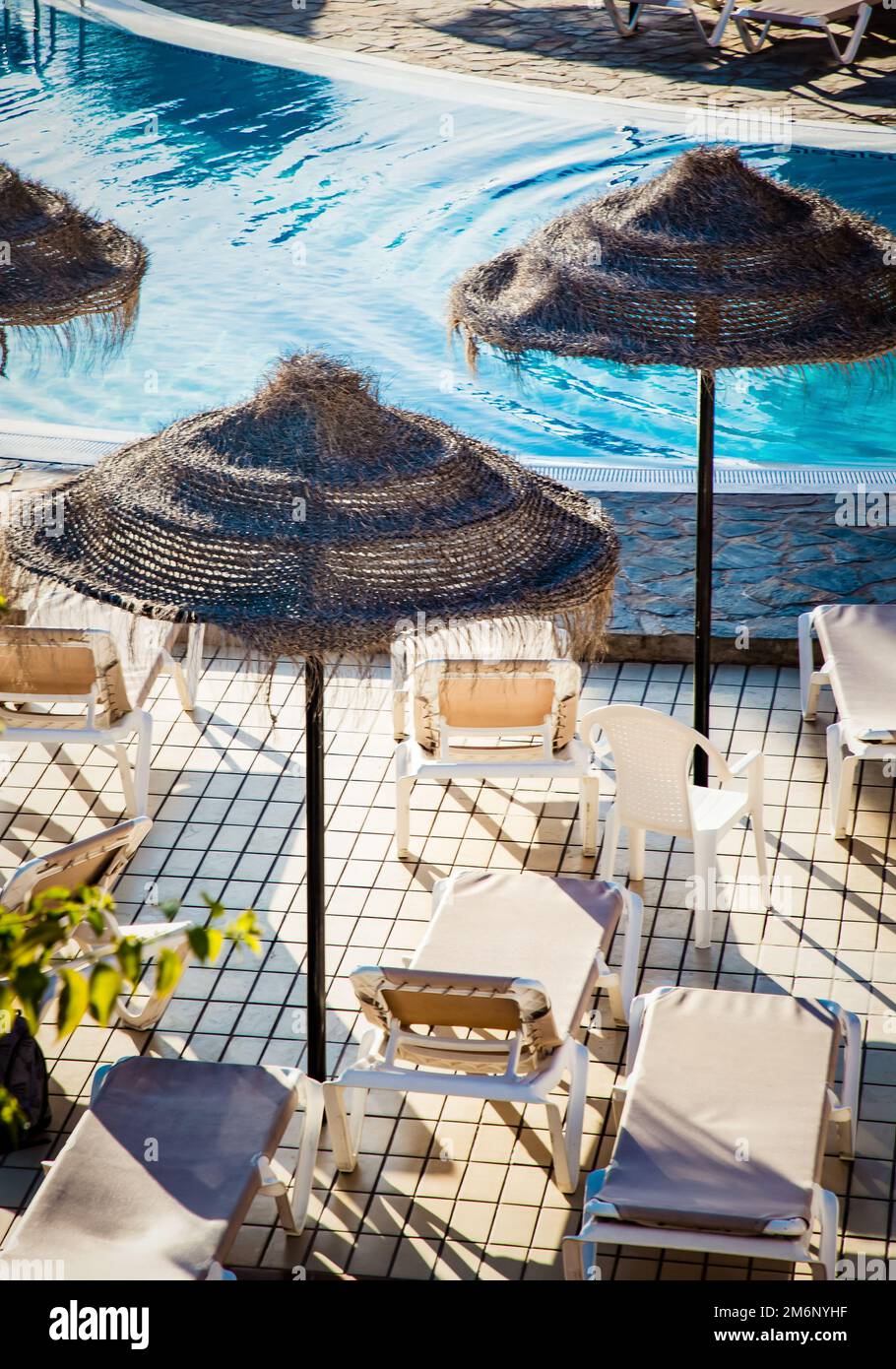Beach umbrellas near a pool Stock Photo - Alamy