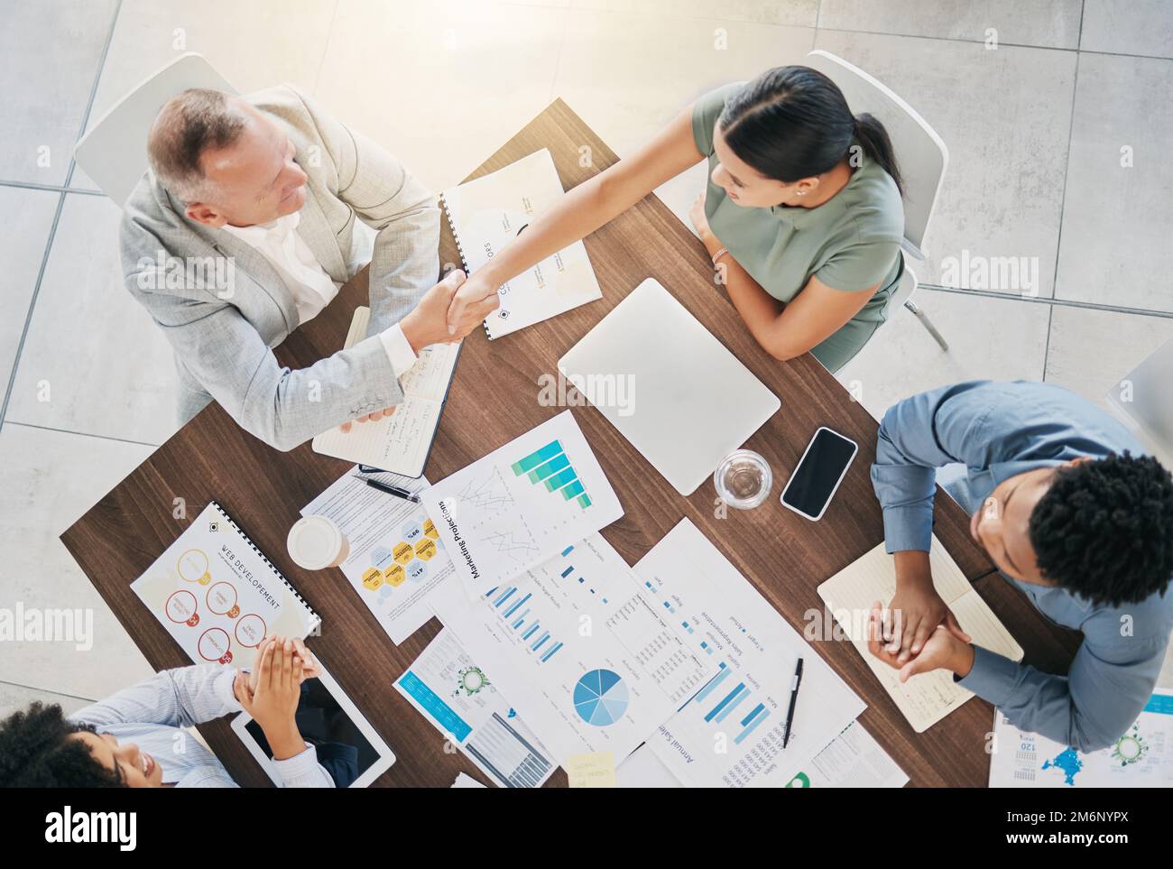 Business people, handshake and meeting with finance report documents ...