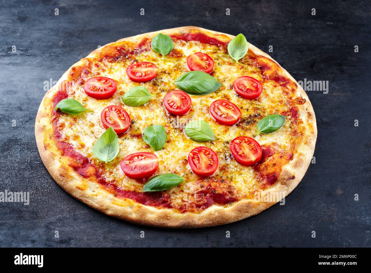 Traditional Neapolitan Italian pizza margherita with tomatoes and mozzarella served as close-up ...