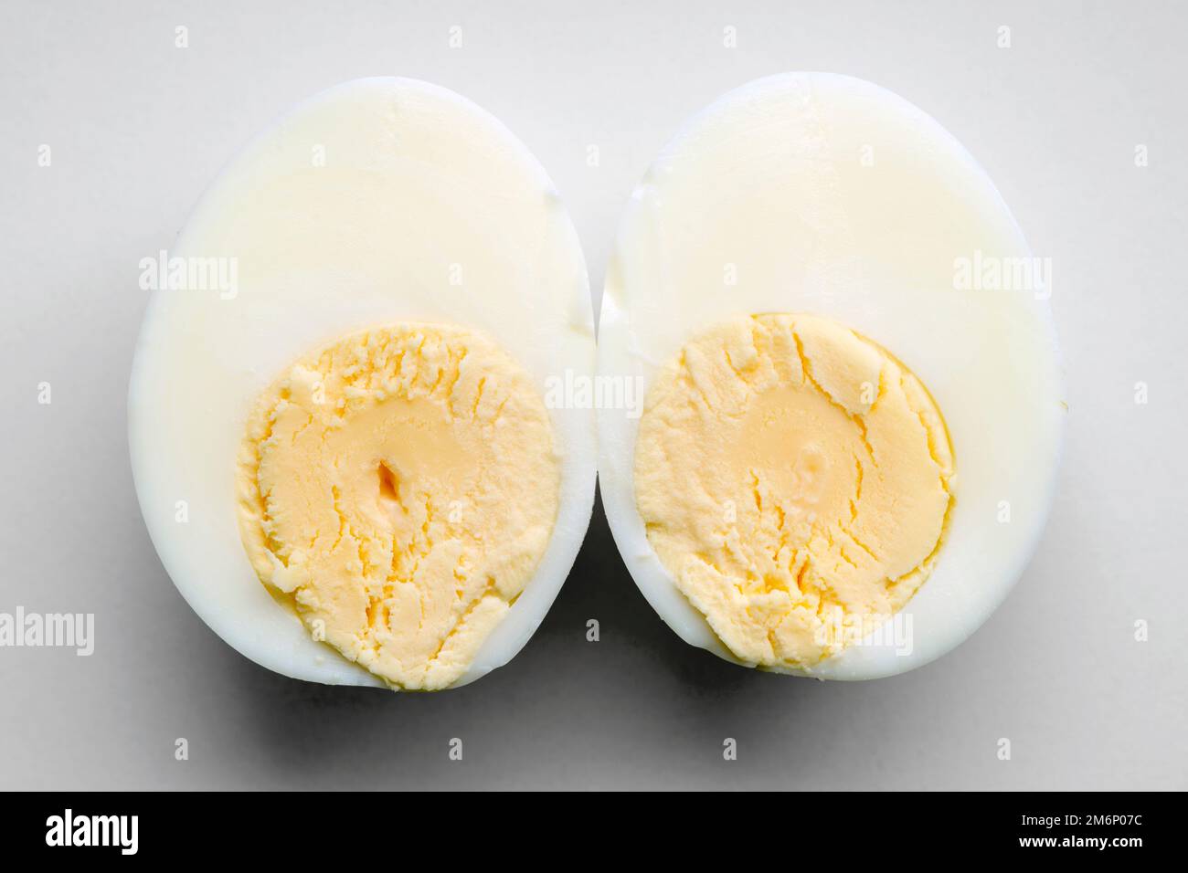 two boiled egg halves isolated on white Stock Photo - Alamy