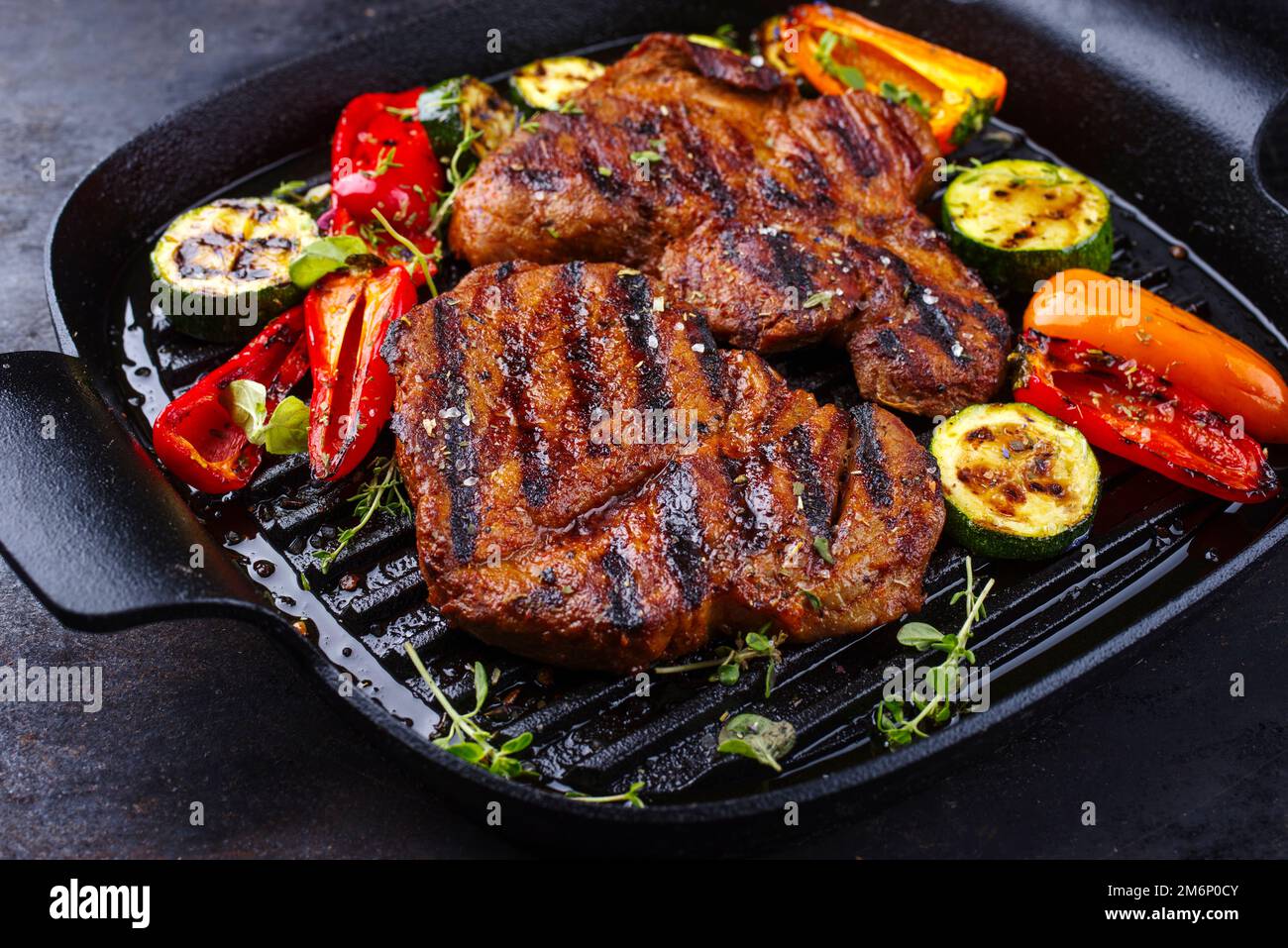 Traditional barbecue pork neck steak with grilled vegetable served and ...