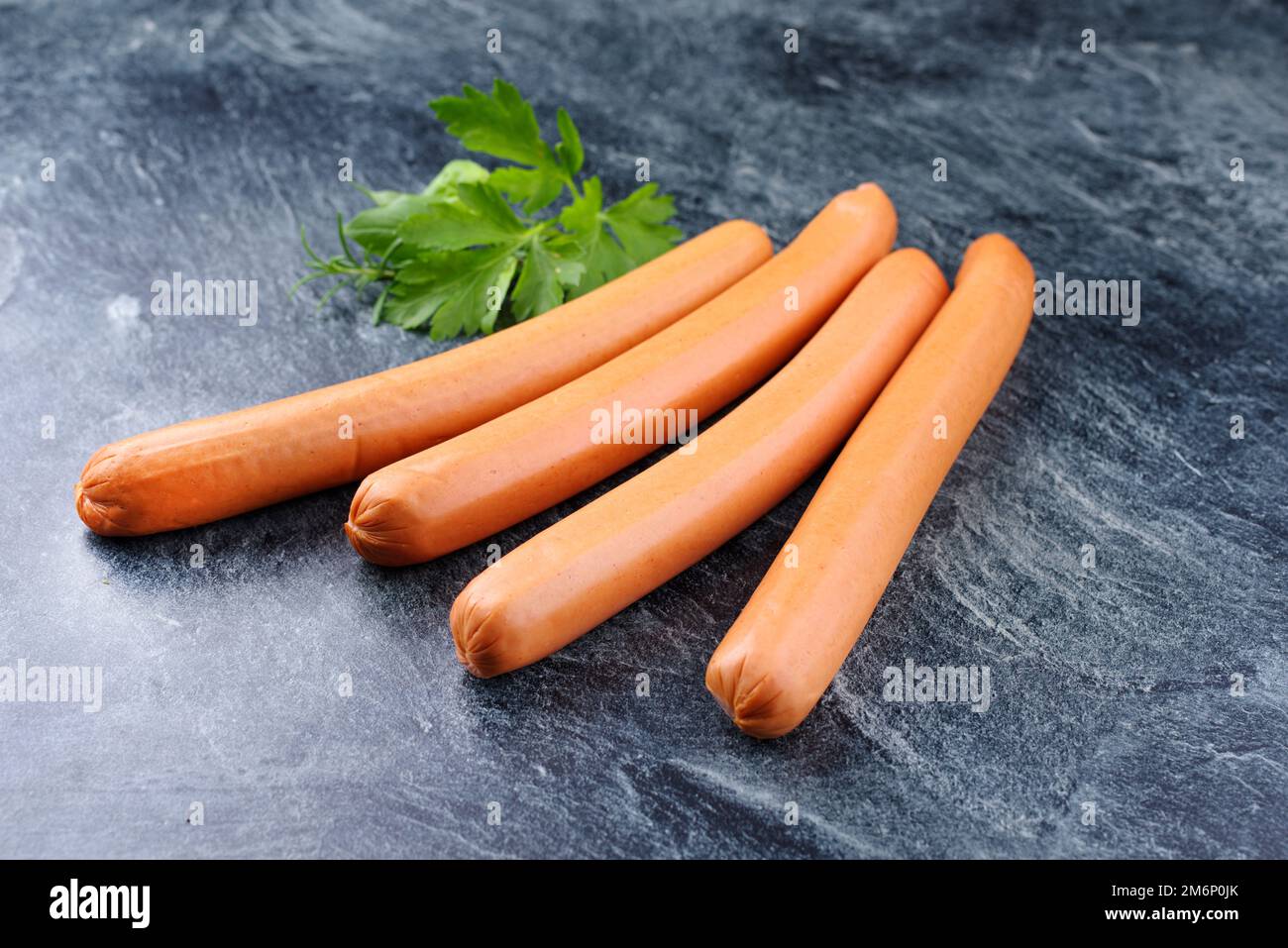 Traditional raw German bockwurst offered as close-up on gray background ...