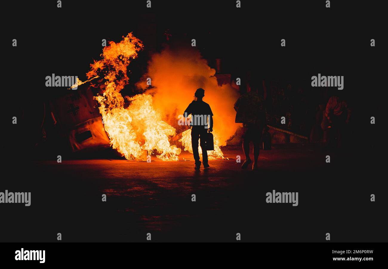 Silhouette of people in front of a fire hi-res stock photography and ...