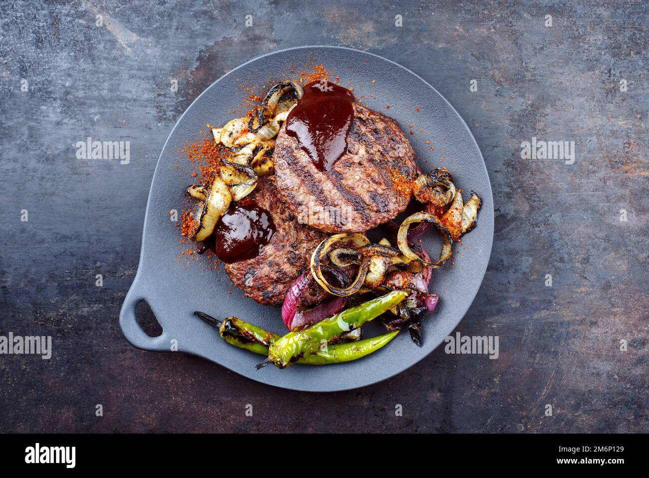 Barbecue wagyu beef Hamburger with grilled chili and onion rings served ...