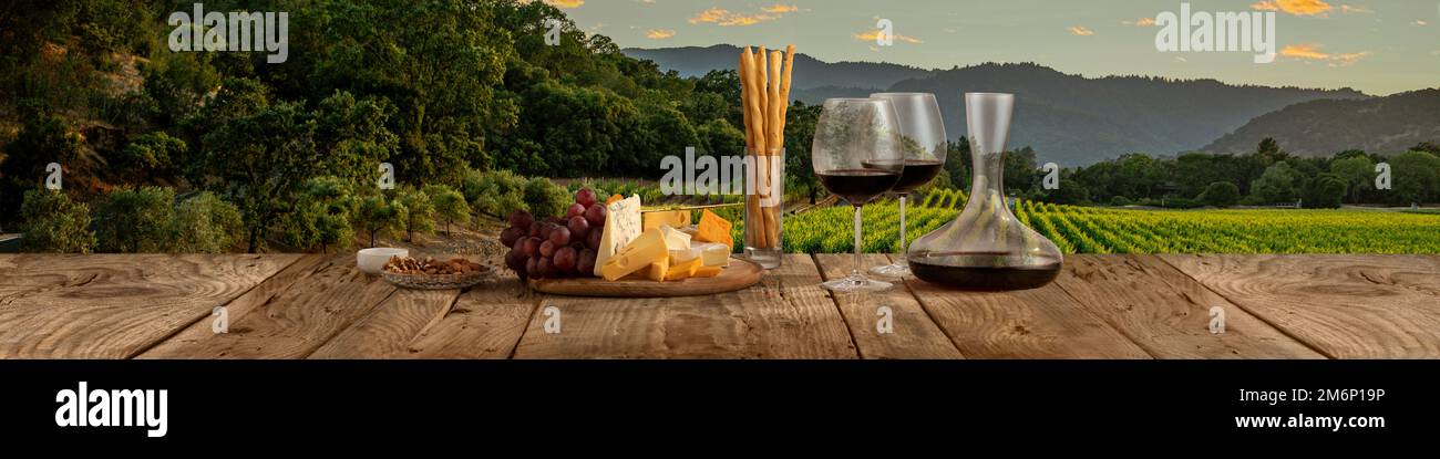 Decanter and two glasses with delicious red wine, grape and cheese ...