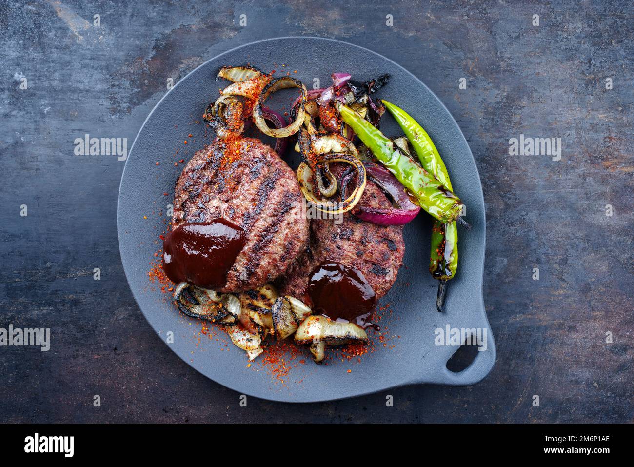 Barbecue wagyu beef Hamburger with grilled chili and onion rings served ...